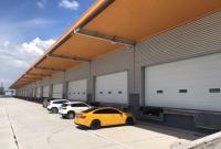 China Customizable 40mm Thickness Wind-Resistant Energy-Saving Industrial Sectional Door for Warehouses for sale