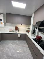 China Laminated Melamine Finish Vertical Wood Grain Frameless Kitchen Cabinet For Home for sale