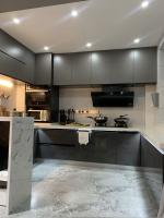 China Modern Design Melamine Finish With Quartz Stone Waterfall Island Kitchen Cabinet for sale