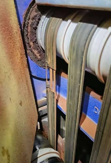 Visible coating damage on an elevator steel belt requiring professional inspection