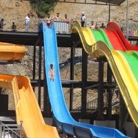 China High-Speed Fiberglass Water Slide 8m Height 65m Length for Amusement Parks with 180 Guests/Hour Capacity for sale