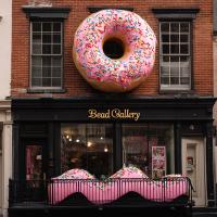 China Life-Size Pink Donut FRP Sculpture 150cm H Customizable Fiberglass Decor for sale