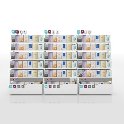 China Facial Mask Combination Cabinet White Wooden Display Rack For Cosmetic Store Decoration And Retail Store Design for sale
