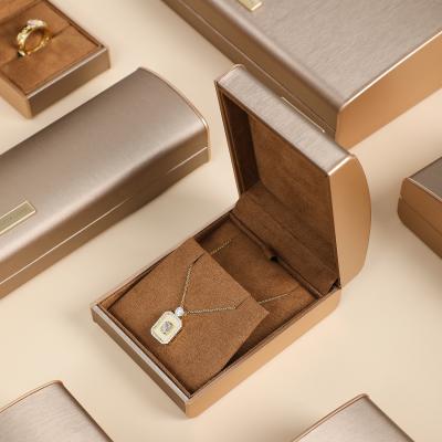 China Custom Champagne Gold Jewelry Box Luxury Ring Necklace Pendant Box With Velvet Lining Wholesale for sale