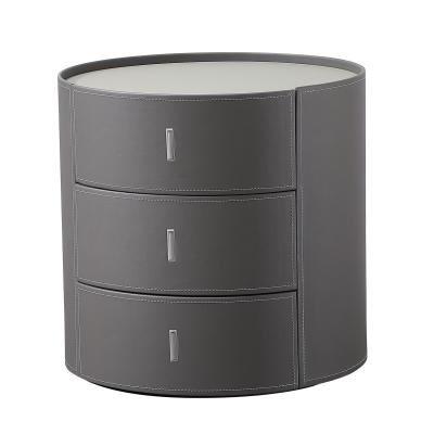 China Modern Luxury Round Leather Bedside Table with 3-Drawer Storage for Bedroom for sale