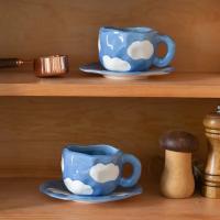China Hand-painted Ceramic Coffee Cup and Saucer Set 250ml Irregular Mug with Blue Sky White Clouds Design for sale