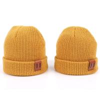 China Custom Cotton Knit Beanie Hat with Leather Patch Adult Size Green for sale