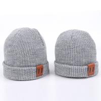 China Custom Cotton Knit Beanie Hat with Leather Patch Adult Size Green for sale