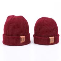 China Custom Cotton Knit Beanie Hat with Leather Patch Adult Size Green for sale