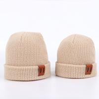 China Custom Cotton Knit Beanie Hat with Leather Patch Adult Size Green for sale