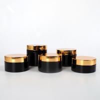 China Wide Mouth PET Round Plastic Canisters 100ml Black Cosmetic Jars With Gold Lid for sale