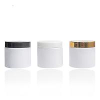 China Wide Mouth PET Round Plastic Canisters 100ml Black Cosmetic Jars With Gold Lid for sale