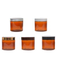 China Wide Mouth PET Round Plastic Canisters 100ml Black Cosmetic Jars With Gold Lid for sale