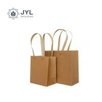 China Custom Logo Ribbon Handle Paper Bag 1000pcs MOQ Moistureproof Cosmetic Packaging for sale