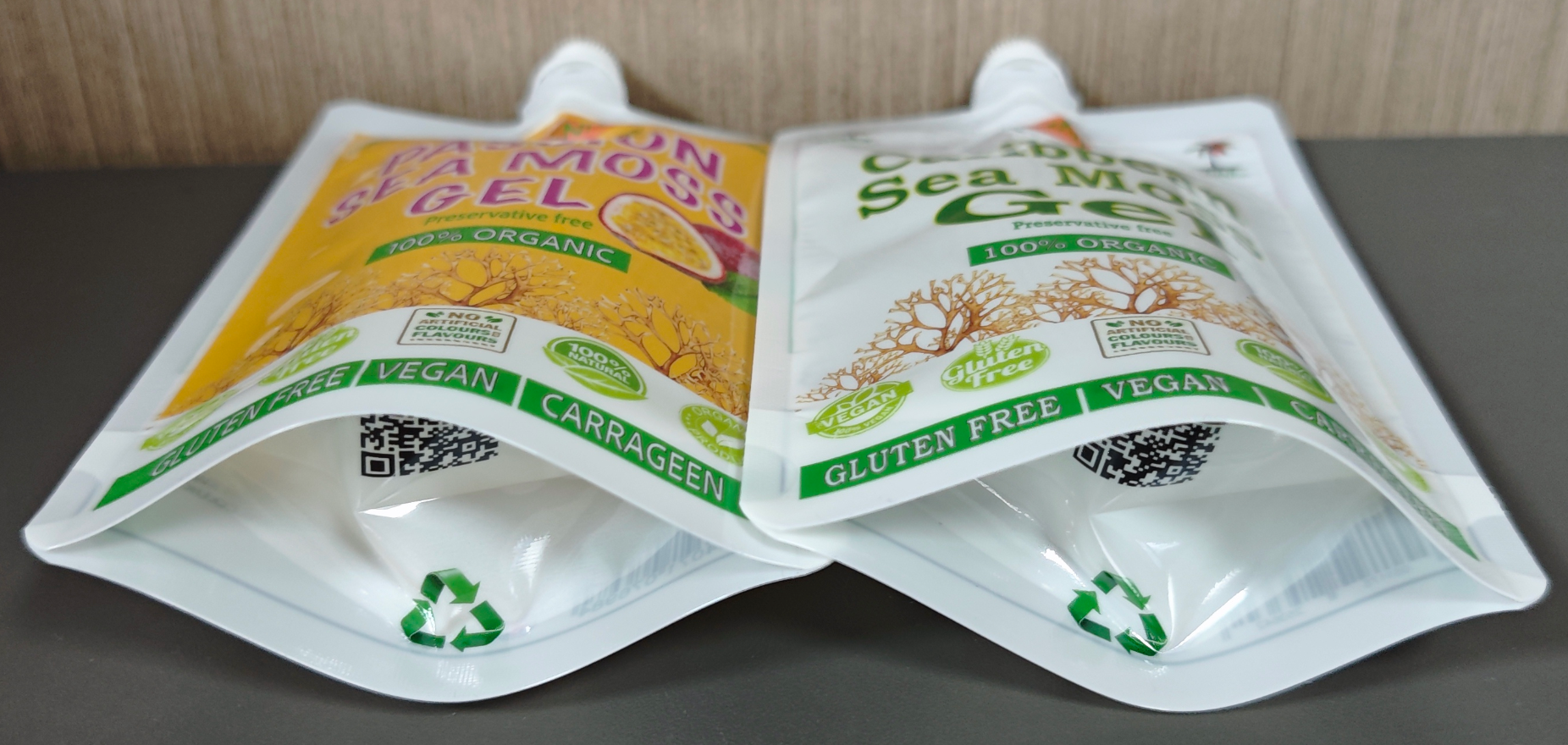 ustom printed recyclable stand up spout pouches for organic sea moss gel packaging, food grade flexible bags with top plastic spout cap, full color custom label printing marked with 100% organic, vegan, gluten free, preservative free logos and recycling symbol at bottom, two flavor variants (passion fruit & original Caribbean sea moss gel), eco-friendly recyclable packaging for natural health edible gel.