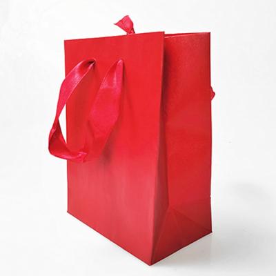 China Leather Paper Bright Red Small Gift Bag For Jewelry Shopping Custom Logo for sale