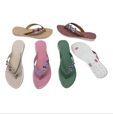 China PVC Women Beach Thongs With Bell Charm Accent And Checkered Embossed Design for sale