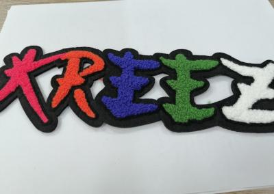 China Custom Towel Embroidered Sew On Labels Washable Patches for Garment 5x3 cm for sale