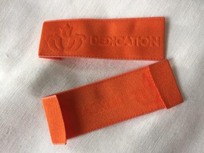 China Needleloom Woven Clothing Labels with High-Frequency Debossing - 50-150 Denier Yarn Options, Multiple Fold Styles for sale