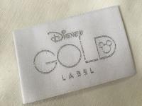 China Disney Gold Foil Woven Clothing Labels - 50-150 Denier Yarn with Ultrasonic Edge Cutting for sale