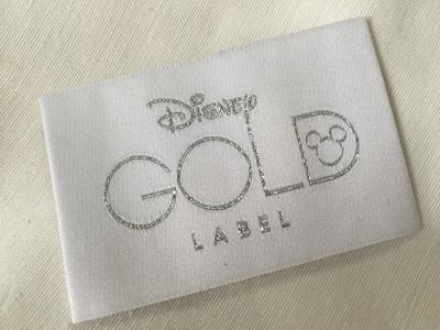 China Disney Gold Foil Woven Clothing Labels - 50-150 Denier Yarn with Ultrasonic Edge Cutting for sale
