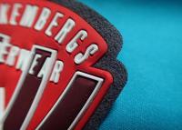 China Custom Logo Embossed Self Adhesive Silicone Clothing Patches 3D Rubber Labels 25x22mm for sale