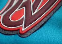 China Custom Logo Embossed Self Adhesive Silicone Clothing Patches 3D Rubber Labels 25x22mm for sale