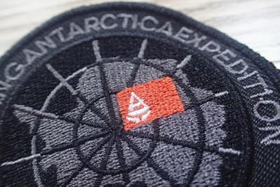 China Custom Embroidered Patches Washable Black Polyester Adhesive 3D Logo Badge for sale