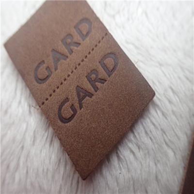 China High Frequency Leather Woven Label 20×30mm with Dashed Points and 1.2mm Thickness for Garment Applications for sale
