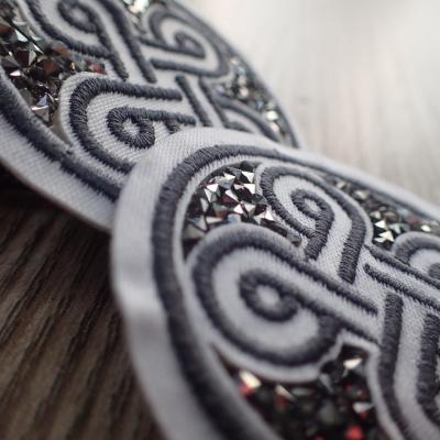 China Custom Imitation Diamond Embroidered Patches 3D Woven Logo with Iron On Backing for sale