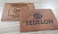 China Custom Embossed Logo PU Leather Patches Sew On Clothing 100 Pcs Min Order for sale