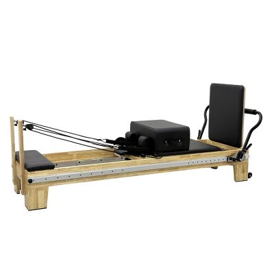 China Custom Rubber Wood Foldable Wooden Pilates Reformer Machine Full Track For Professional Studios for sale