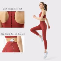 China Hollow Out Knot Yoga Set Clothes Big Hidden Back Pocket Yoga Leggings Set for sale
