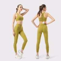 China Hollow Out Knot Yoga Set Clothes Big Hidden Back Pocket Yoga Leggings Set for sale