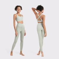 China Solid Color Women's 2 Piece Yoga Set Sexy Cross Back Bra Sports Clothes Yoga Leggings for sale