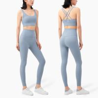 China Cross Back Yoga Set Clothes Gathered Belly Matching Sports Bra And Leggings Set for sale