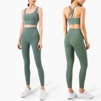 China Cross Back Yoga Set Clothes Gathered Belly Matching Sports Bra And Leggings Set for sale