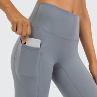 China Hip Lifting High Waisted Tights Pants Nylon Women's Yoga Pants With Side Pockets for sale