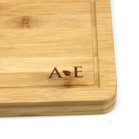 China Stocked Eco-Friendly Kitchenware Multi-Purpose Solid Wood Cutting Board with Handle for sale
