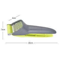 China Stainless Steel Garlic Press With Ergonomic Handle And Easy-Clean Basket for sale