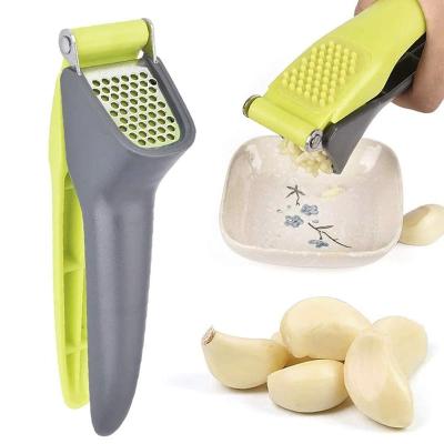 China Stainless Steel Garlic Press With Ergonomic Handle And Easy-Clean Basket for sale