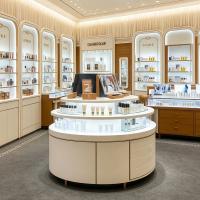 China Custom Luxury Cosmetic Display Cabinet with French-style Arched Design and Eco-friendly Solid Wood for Professional Beauty Boutique Display for sale