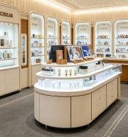 China Custom Luxury Cosmetic Display Cabinet with French-style Arched Design and Eco-friendly Solid Wood for Professional Beauty Boutique Display for sale
