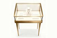 China Luxury Brushed Gold Frame Jewelry Display Cabinet with Built-In LED Light and Lockable Storage Drawer for sale