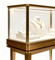 China Luxury Brushed Gold Frame Jewelry Display Cabinet with Built-In LED Light and Lockable Storage Drawer for sale