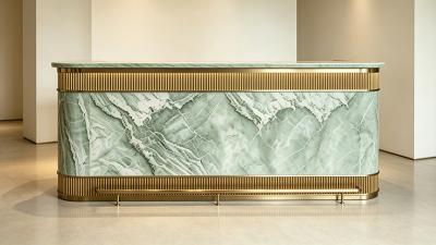 China Freestanding Natural Green Jade Marble Retail Reception Desk with Full Gold Metal Frame for High-End Boutique Stores for sale