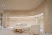 China Wabi Sabi Minimalist Women Clothing Store Interior Design with Natural Travertine Curved Wall and Multi-functional Zoning Layout for sale
