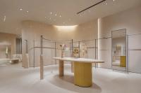 China Wabi Sabi Minimalist Women Clothing Store Interior Design with Natural Travertine Curved Wall and Multi-functional Zoning Layout for sale