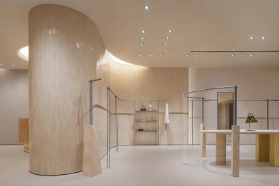 China Wabi Sabi Minimalist Women Clothing Store Interior Design with Natural Travertine Curved Wall and Multi-functional Zoning Layout for sale