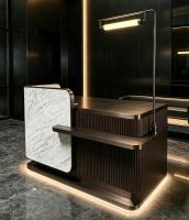 China Luxury Fluted Bronze Reception Counter with Marble Side Panel and Base LED Light for High-End Hotels for sale